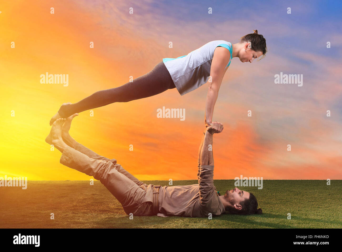 The two people doing yoga exercises Stock Photo - Alamy