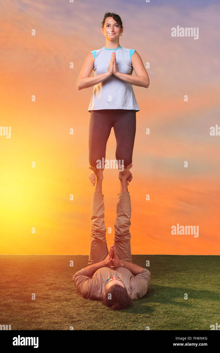 The two people doing yoga exercises Stock Photo - Alamy