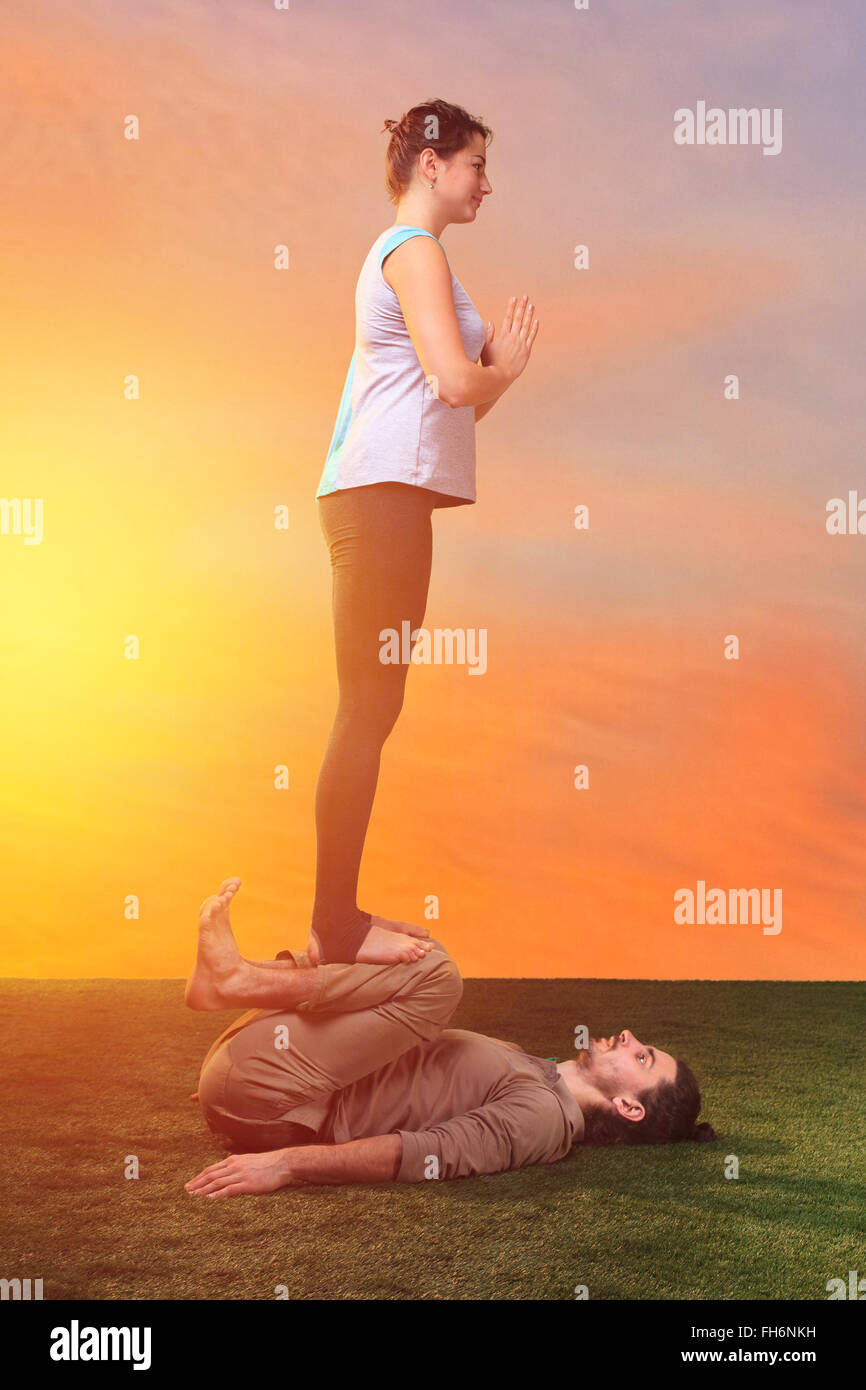 The two people doing yoga exercises Stock Photo - Alamy