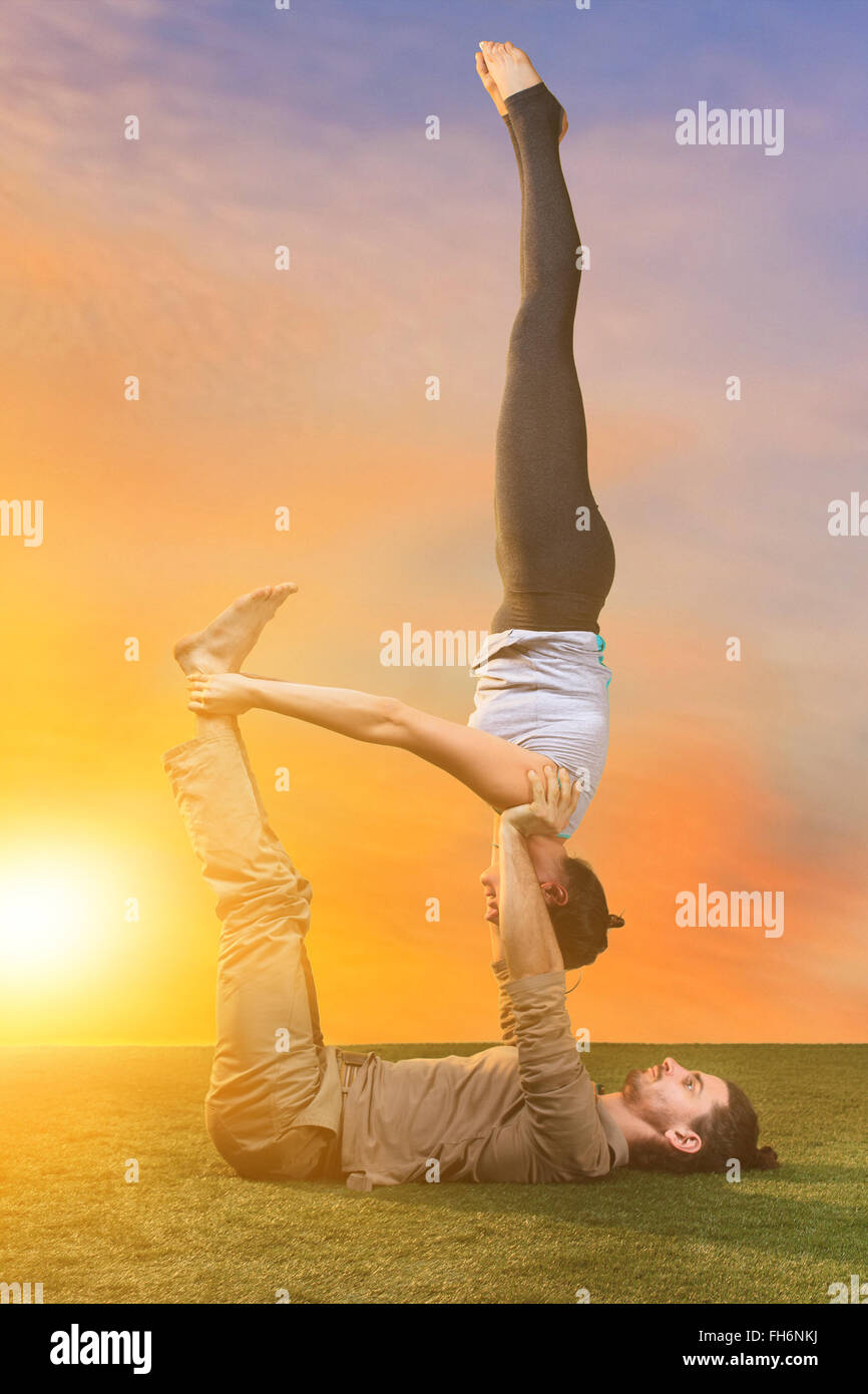 The two people doing yoga exercises Stock Photo - Alamy