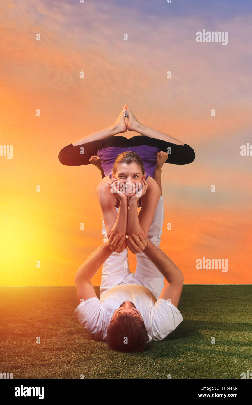The two people doing yoga exercises Stock Photo - Alamy