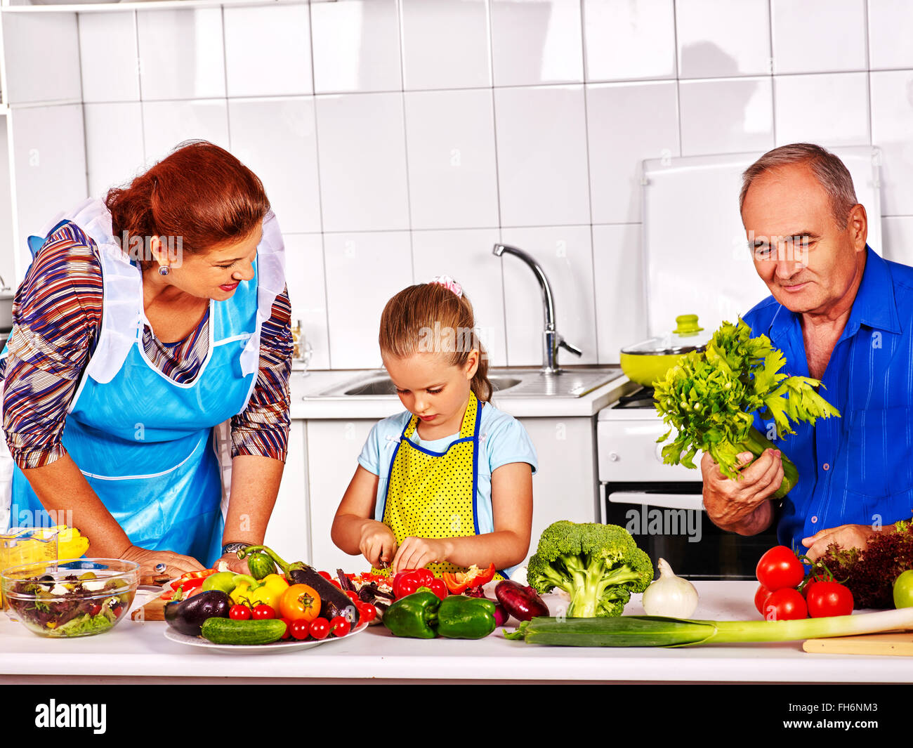 Family with child cooking at kitchen Stock Photo - Alamy