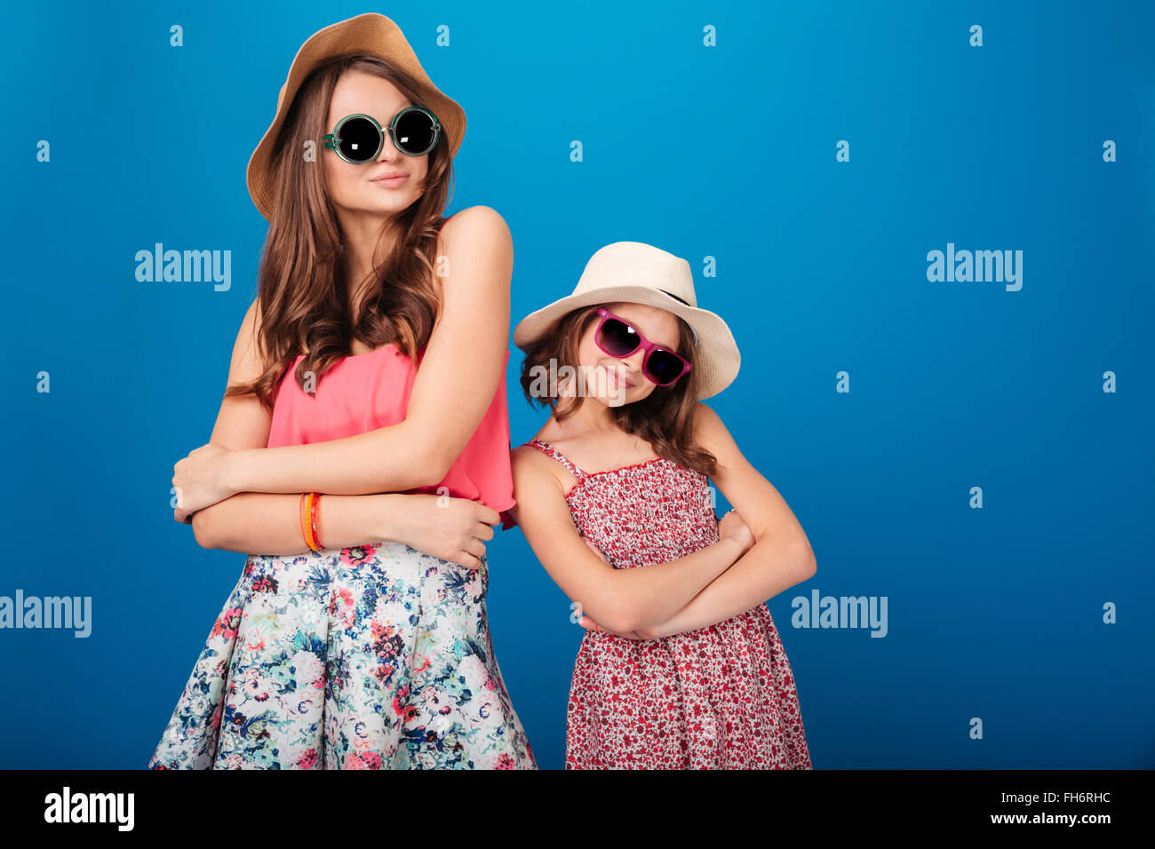 Two sisters standing together isolated hi-res stock photography and ...