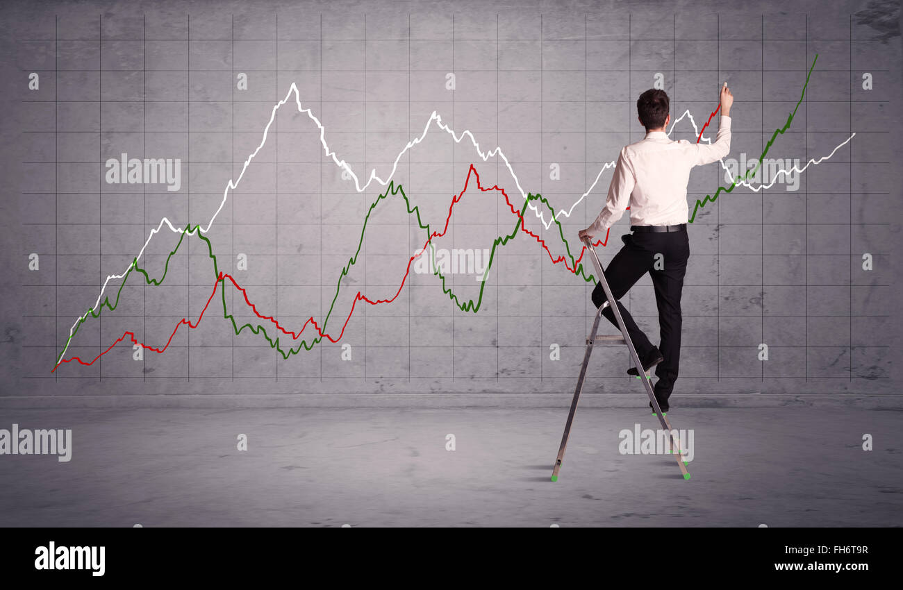 male on ladder drawing chart lines Stock Photo - Alamy