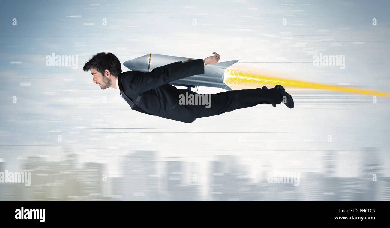 Superhero business man flying with jet pack rocket above the city Stock ...