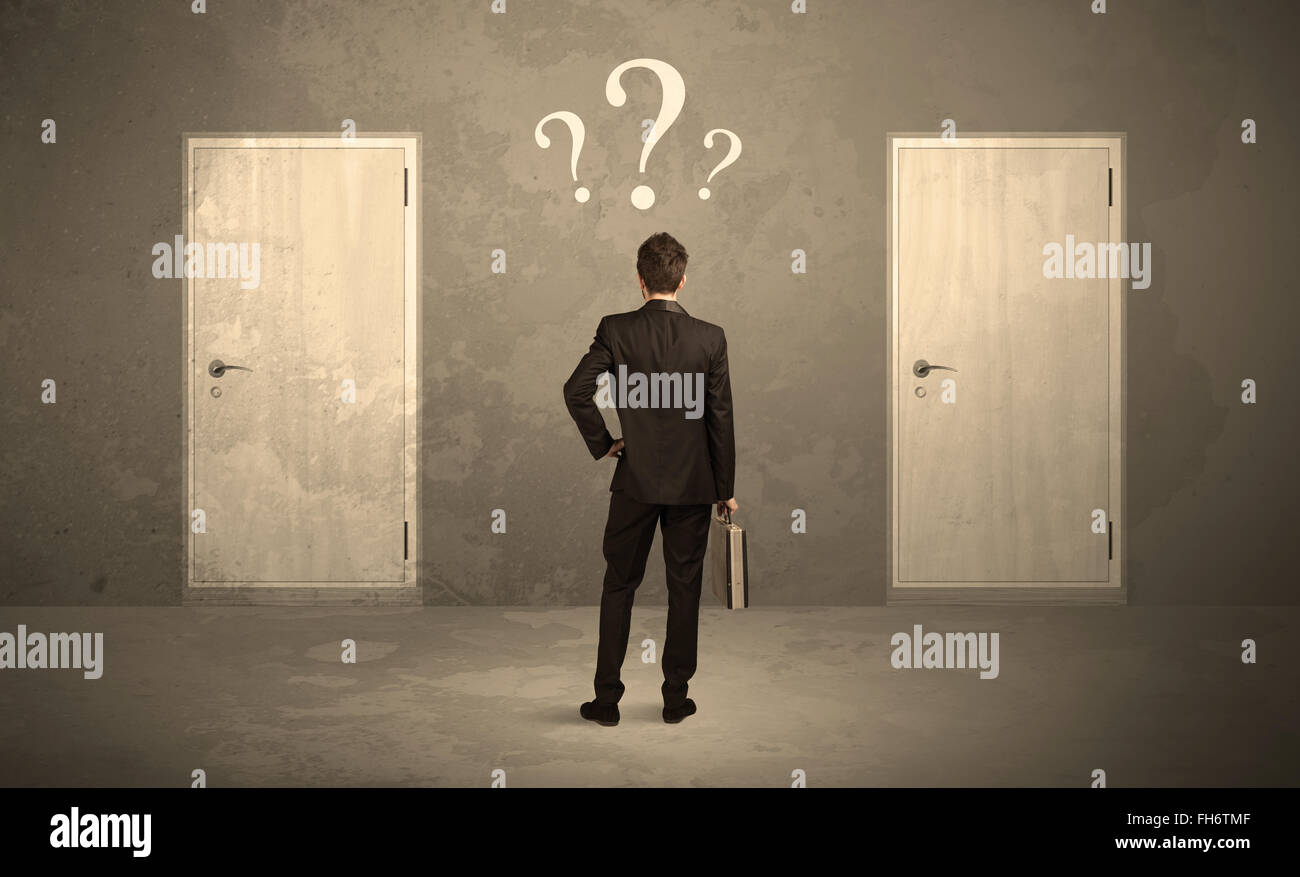 Confused businessman choosing right door hi-res stock photography and ...