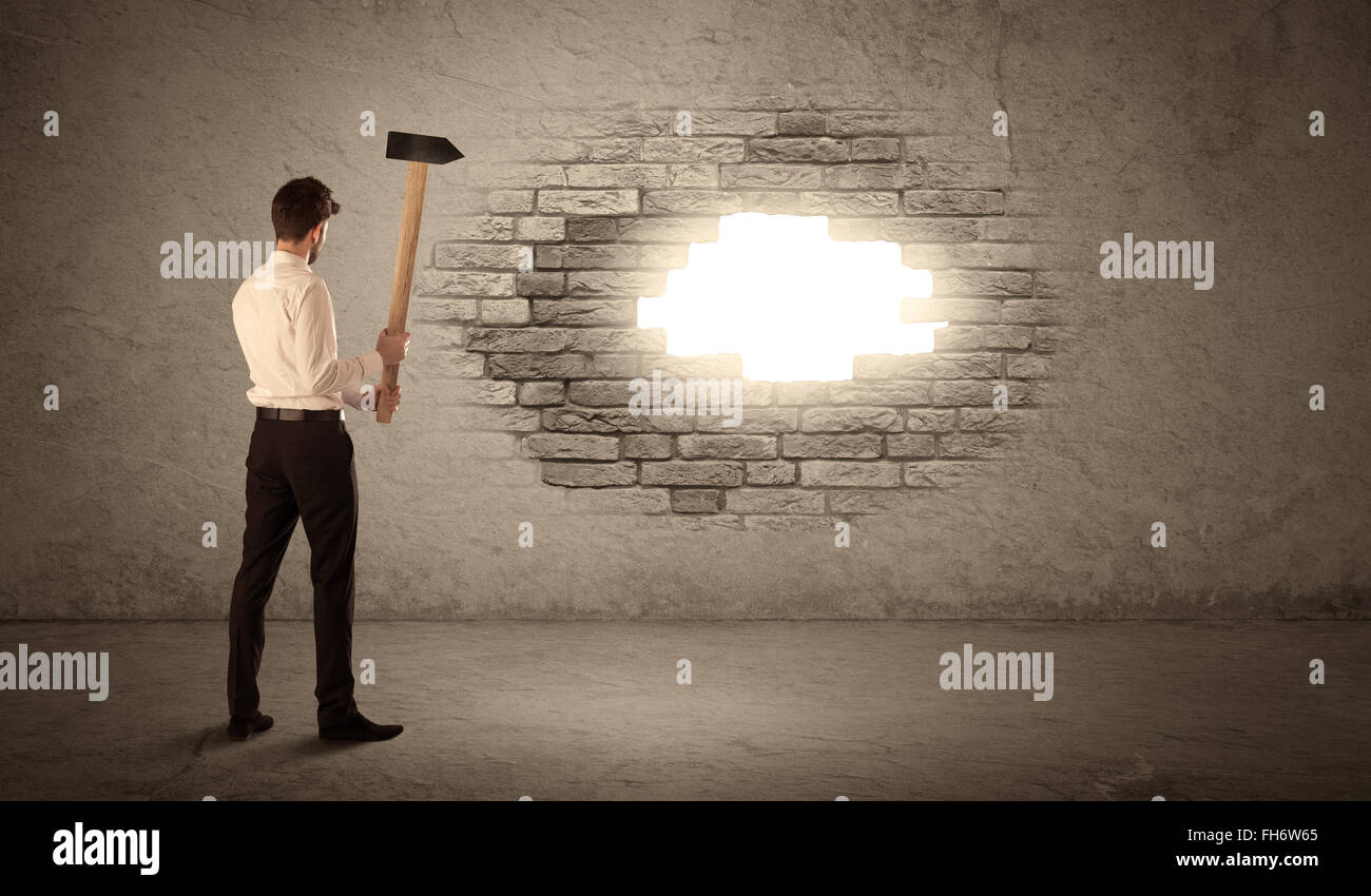Business man hitting brick wall with hammer and opening a hole Stock ...
