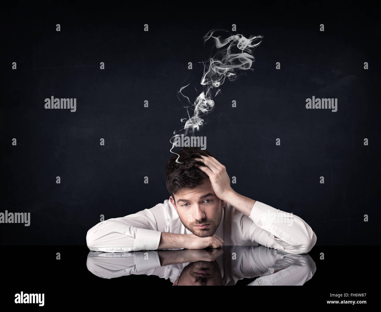 Depressed businessman with smoking head Stock Photo - Alamy