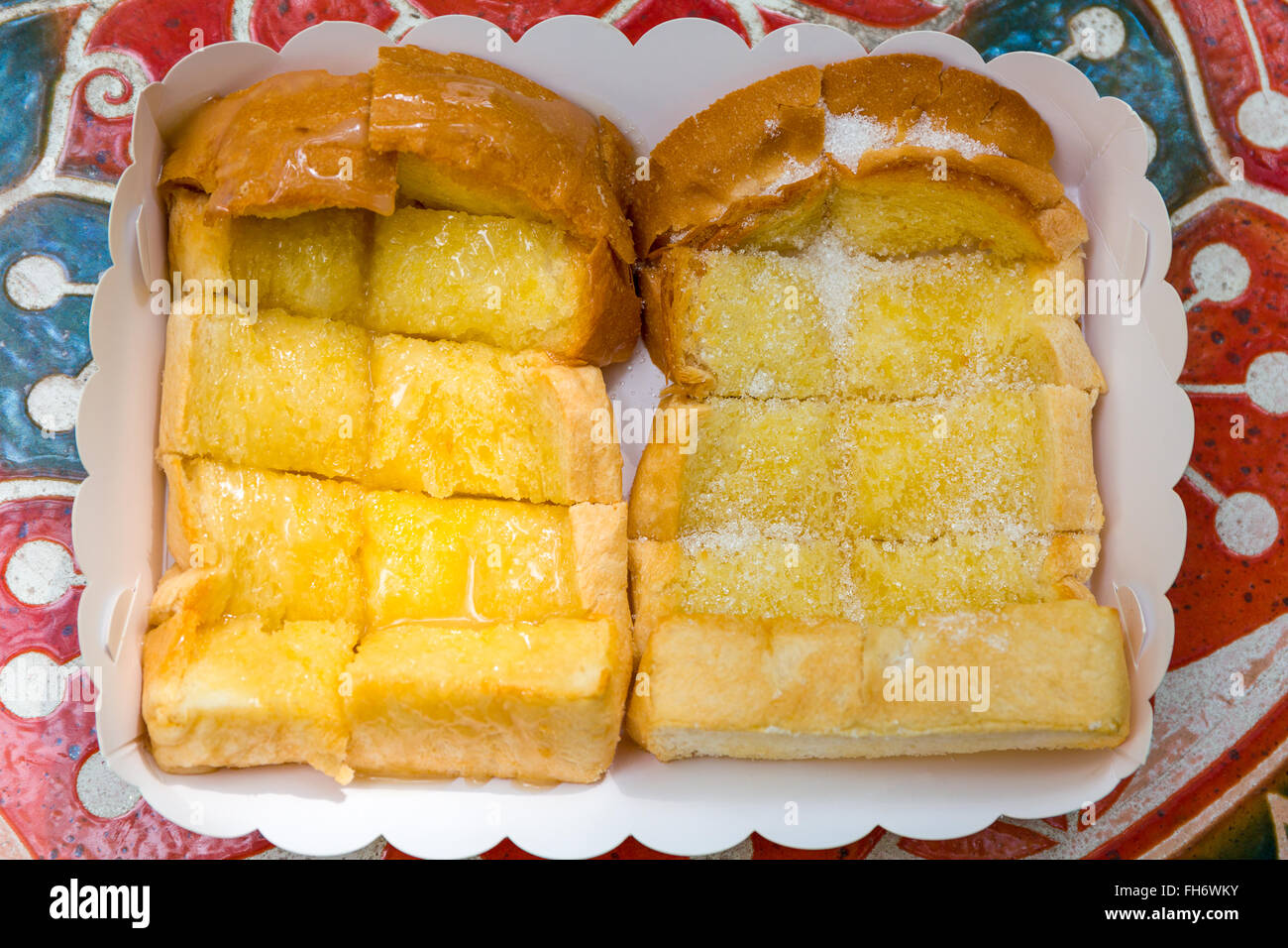 Toasted bread with sugar and butter spread as dessert Stock Photo - Alamy
