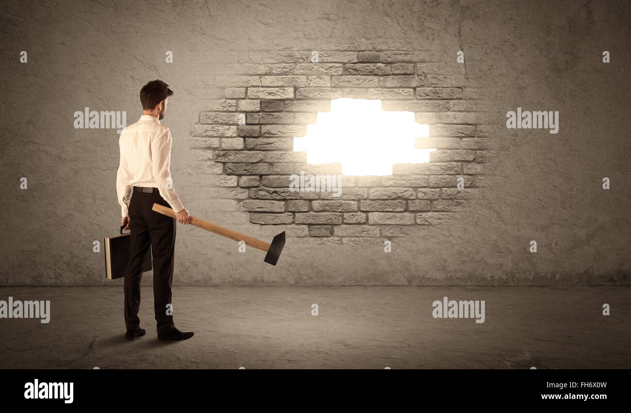 Business man hitting brick wall with hammer and opening a hole Stock ...