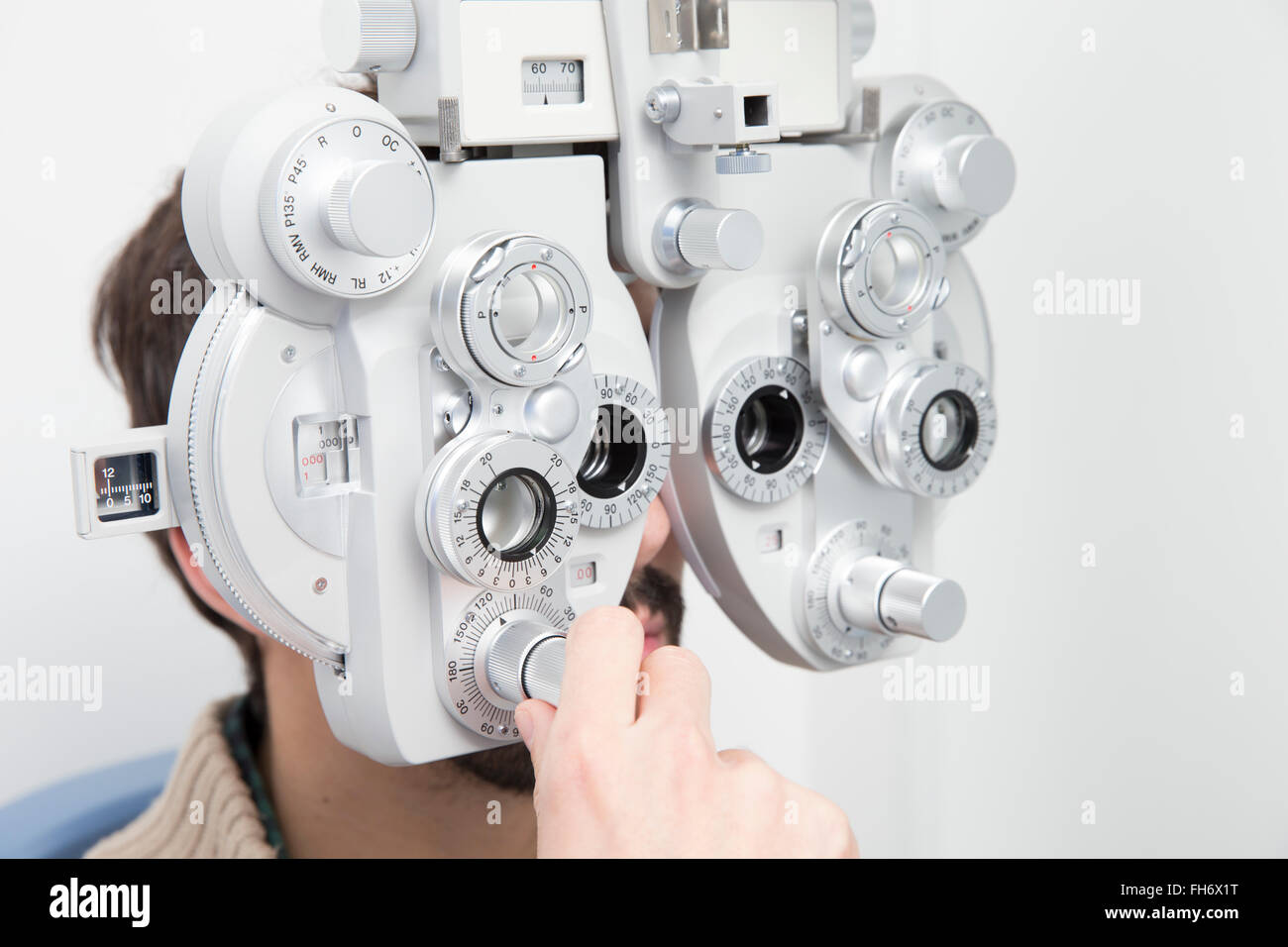Man at the optometrist making an eye test Stock Photo - Alamy