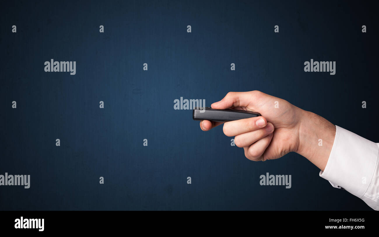Hand with remote control Stock Photo - Alamy
