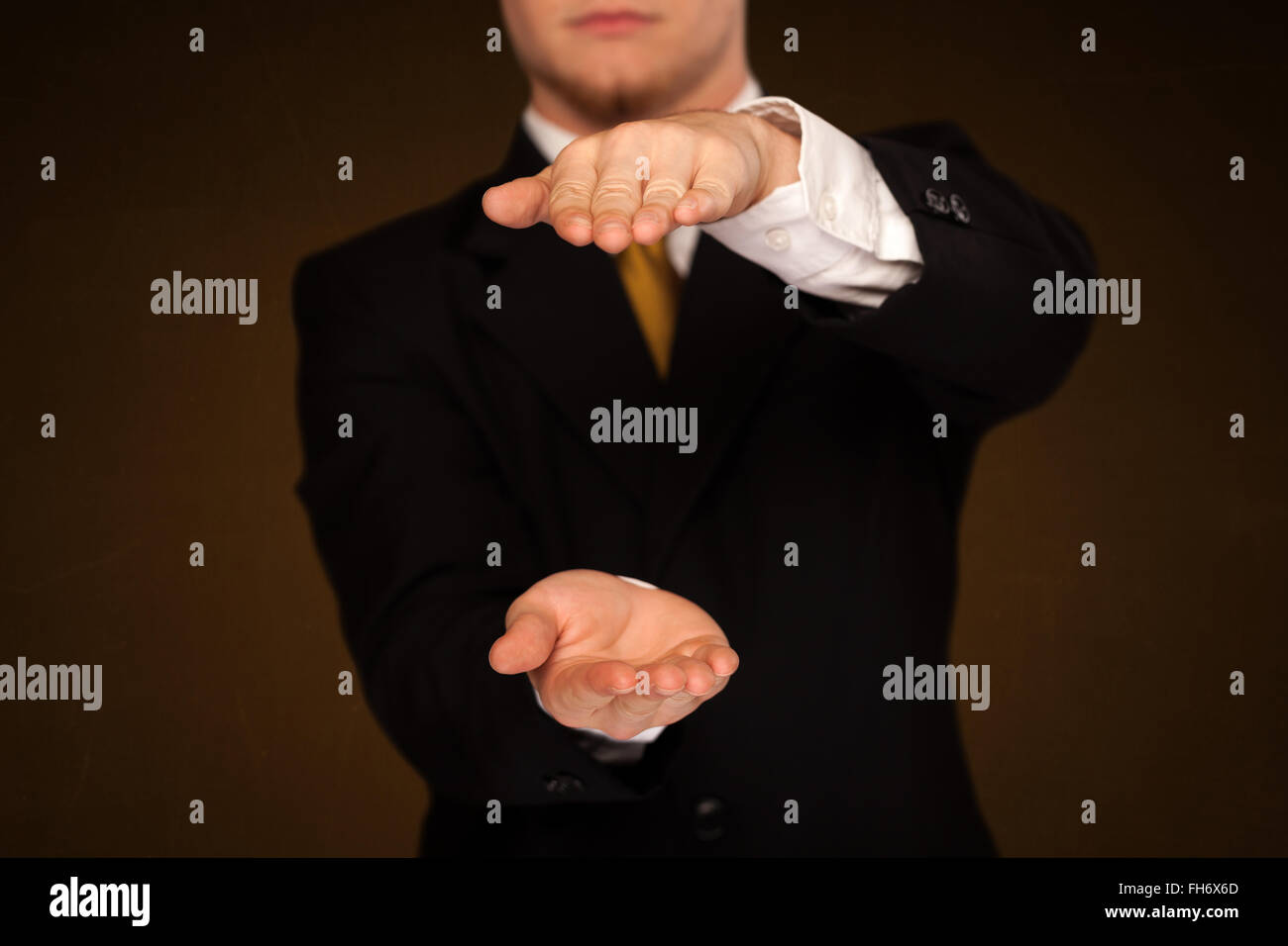 Businessman holding something Stock Photo - Alamy