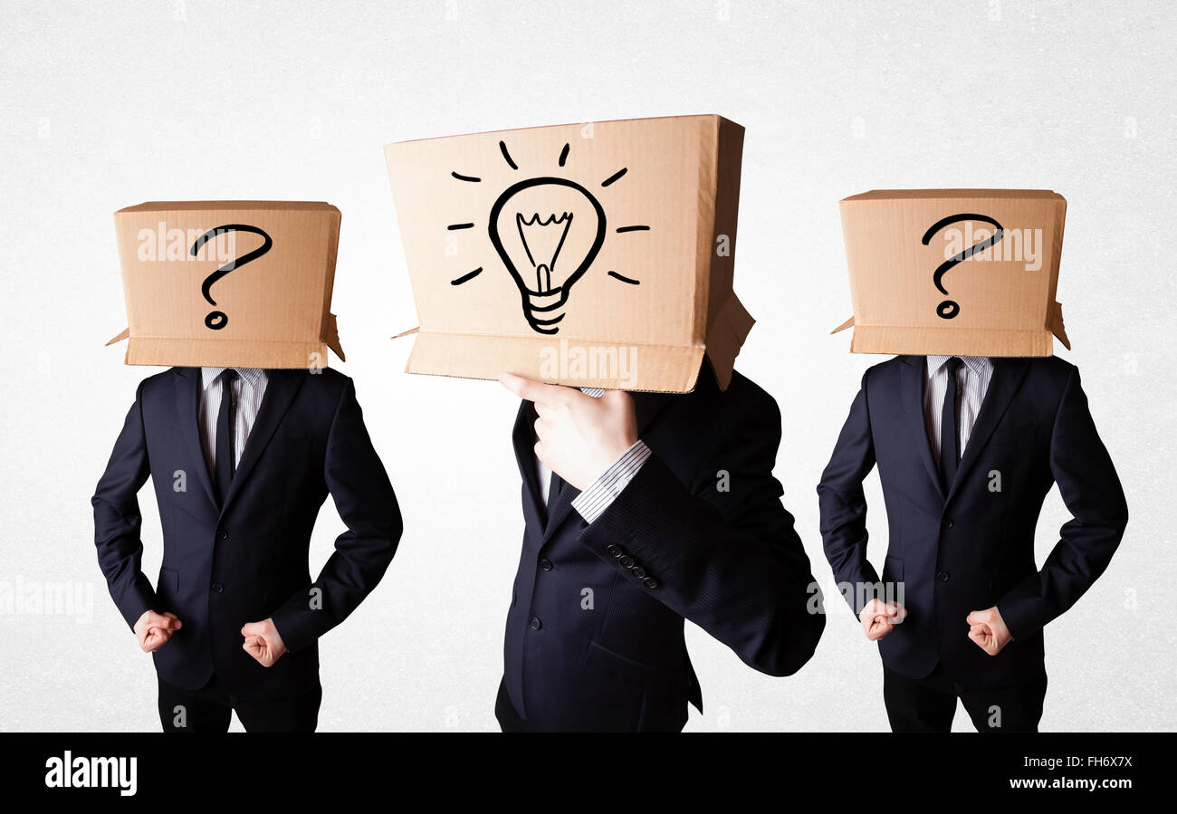 Handsome men in suit gesturing with drawn signs and symbols on box ...