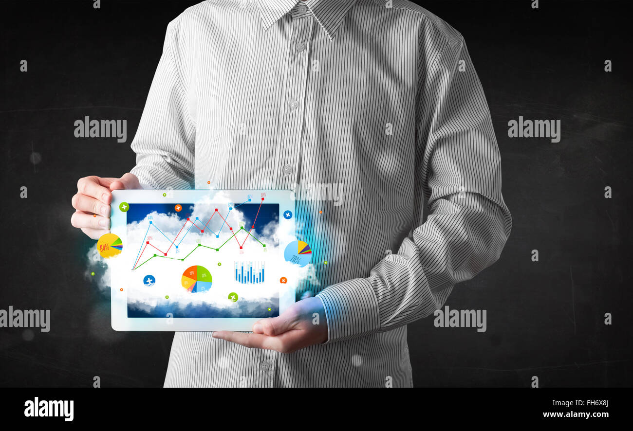 Person holding a touchpad with cloud technology and charts Stock Photo ...