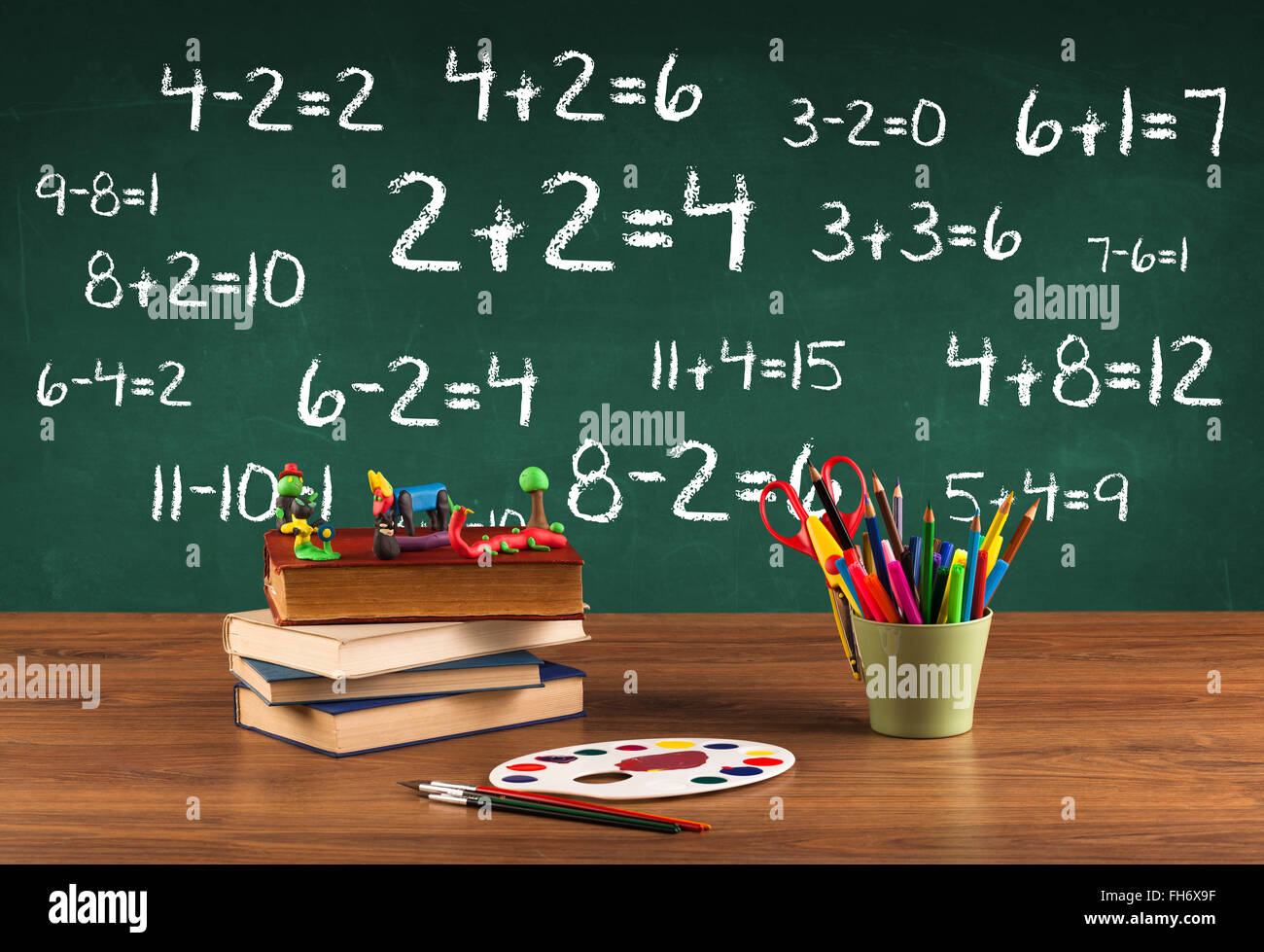 School blackboard with pile of books Stock Photo - Alamy