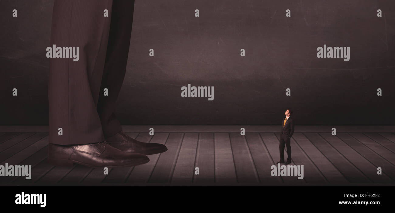 Big person with small businessman concept Stock Photo - Alamy