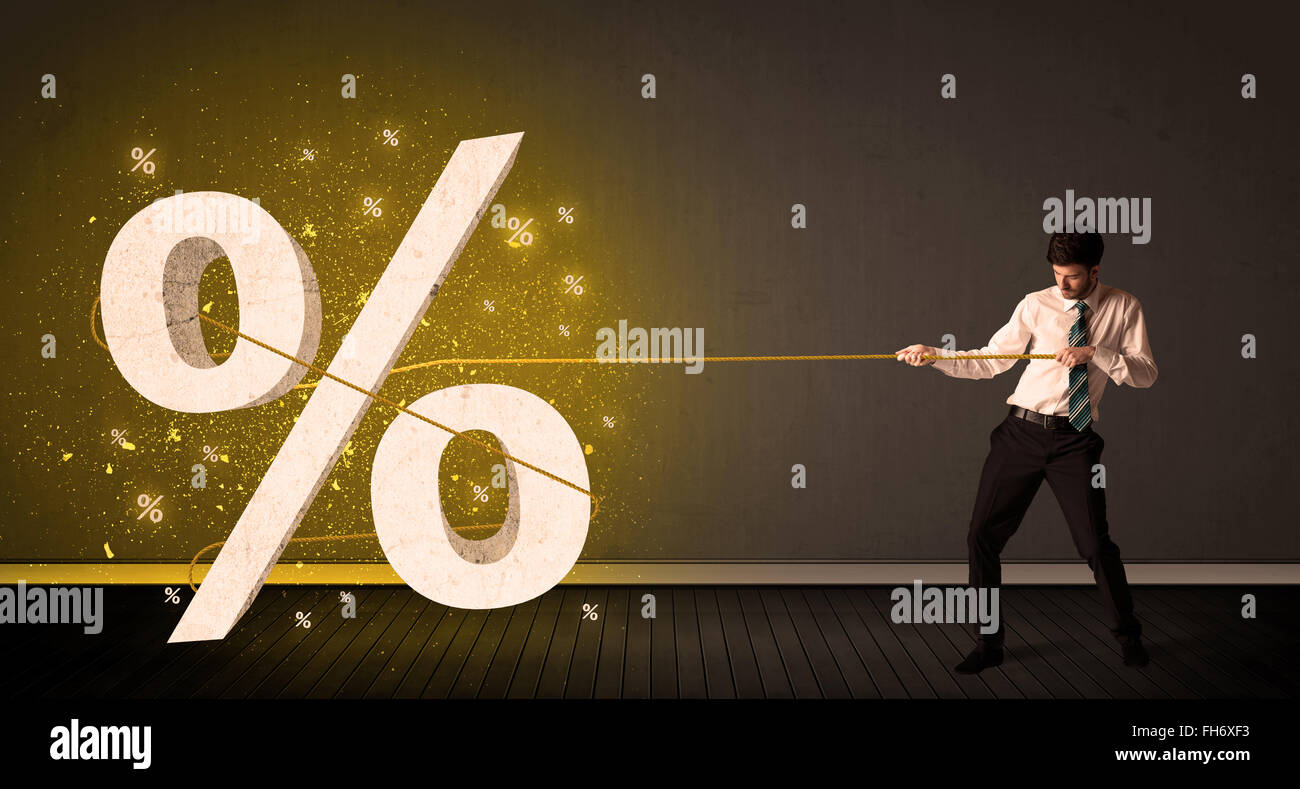 Business man pulling rope with big procent symbol sign Stock Photo - Alamy