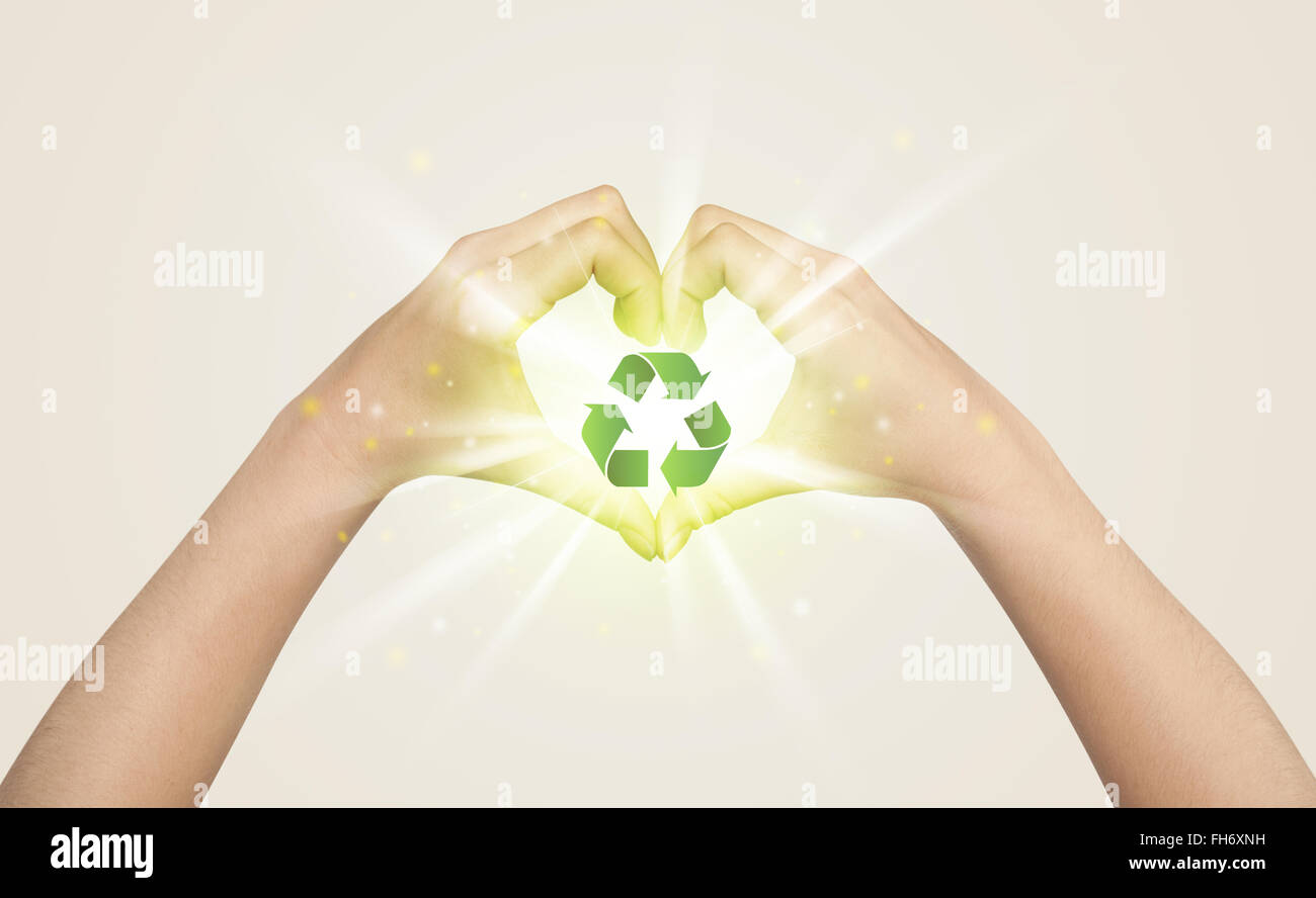 Hands creating a form with recycling sign Stock Photo - Alamy
