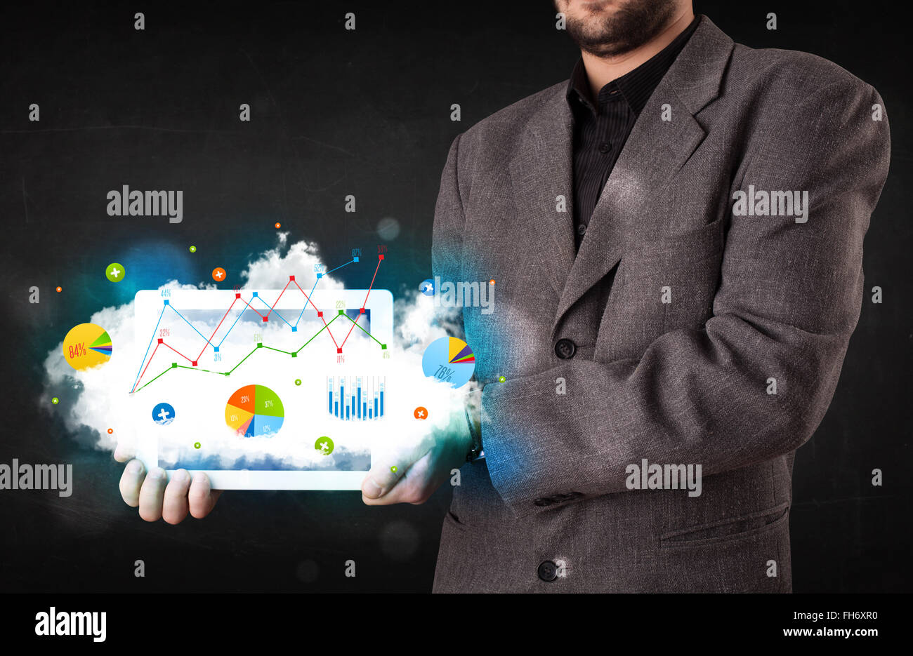 Person holding a touchpad with cloud technology and charts Stock Photo ...