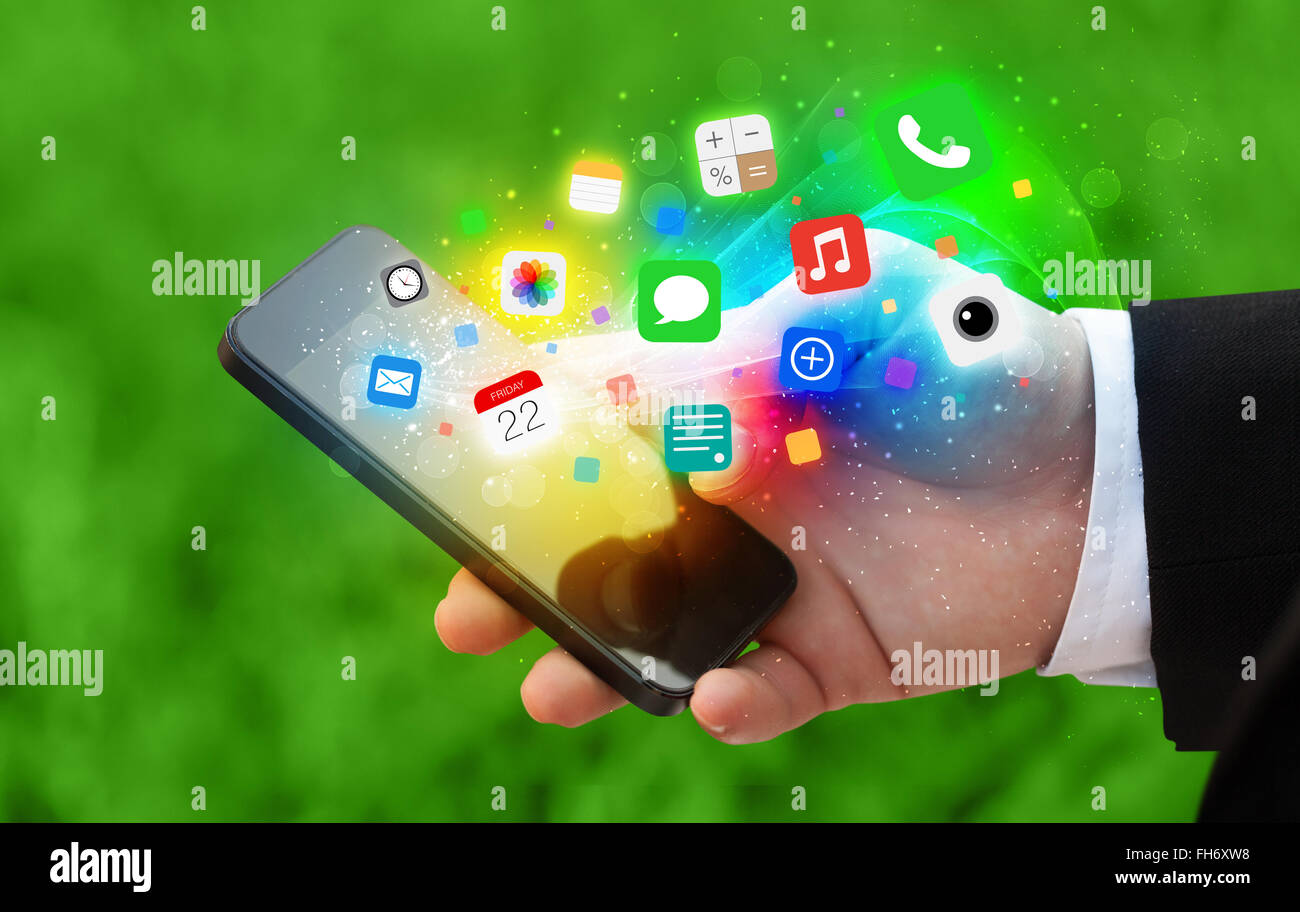 Hand holding smartphone with colorful app icons Stock Photo - Alamy