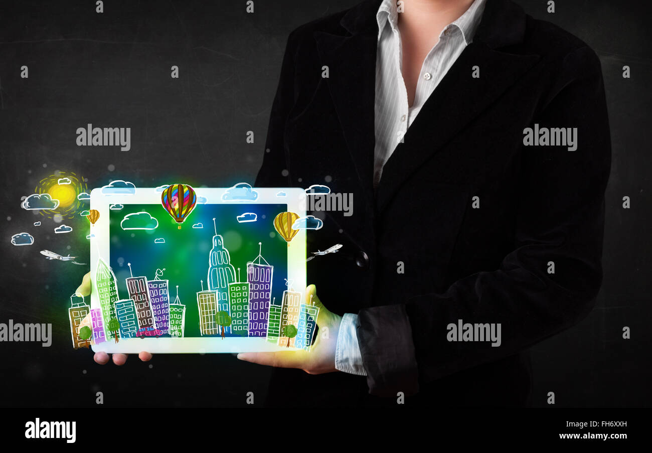 Young person showing tablet with hand drawn cityscape Stock Photo - Alamy