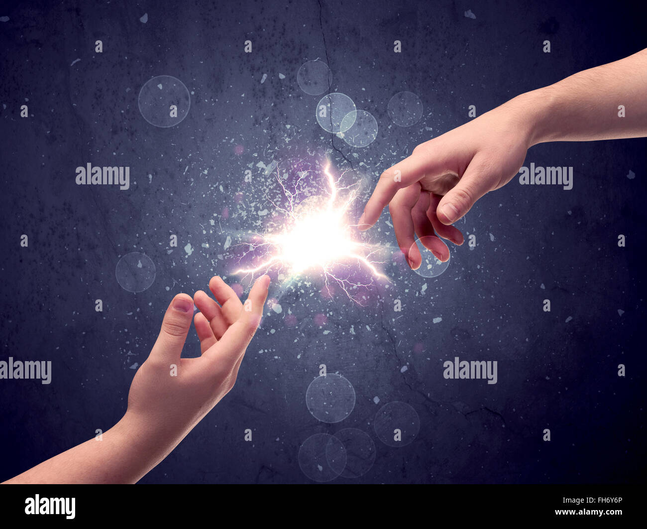 Hands reaching to light a spark Stock Photo - Alamy