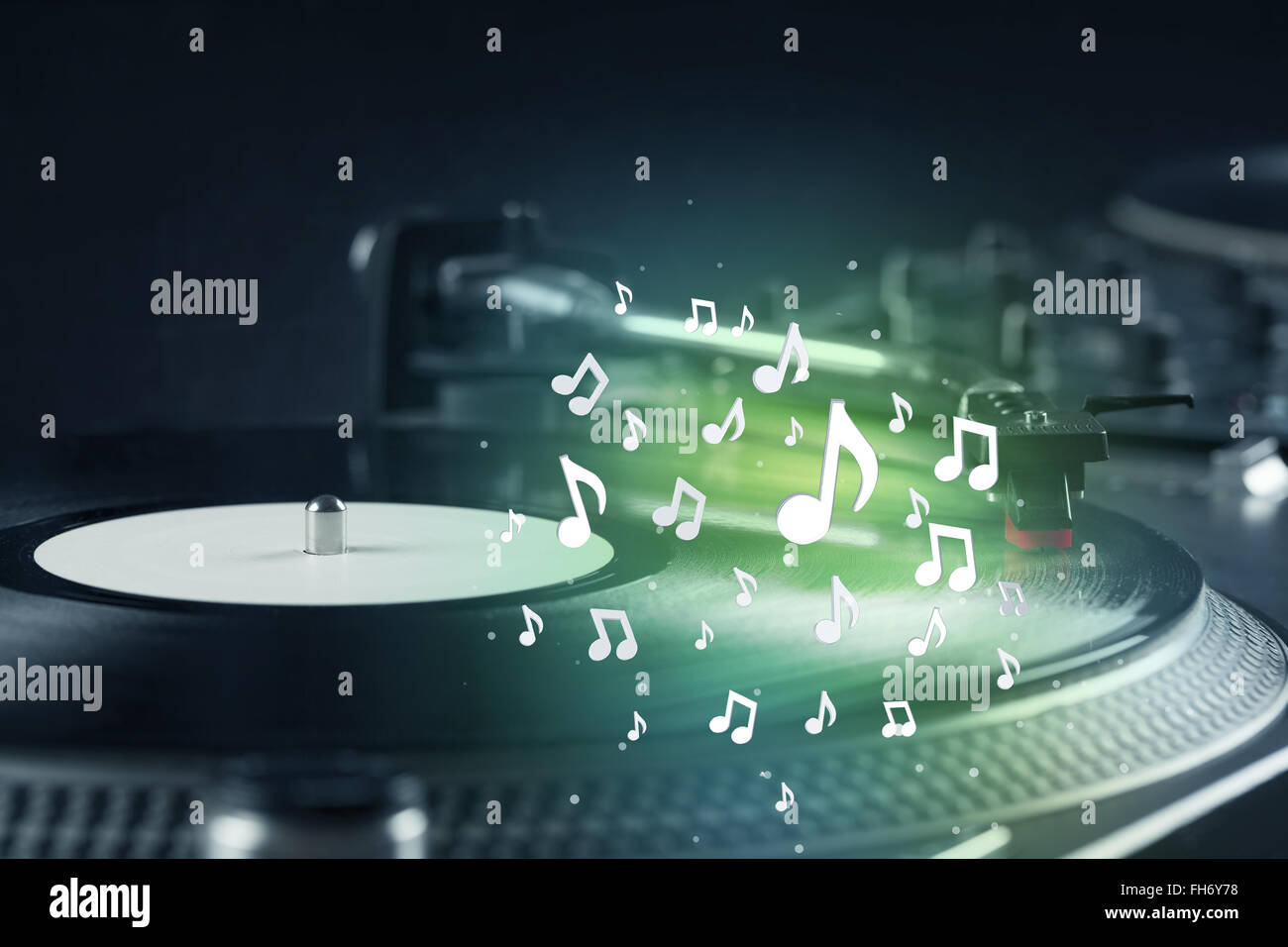 Turntable playing music with audio notes glowing Stock Photo - Alamy