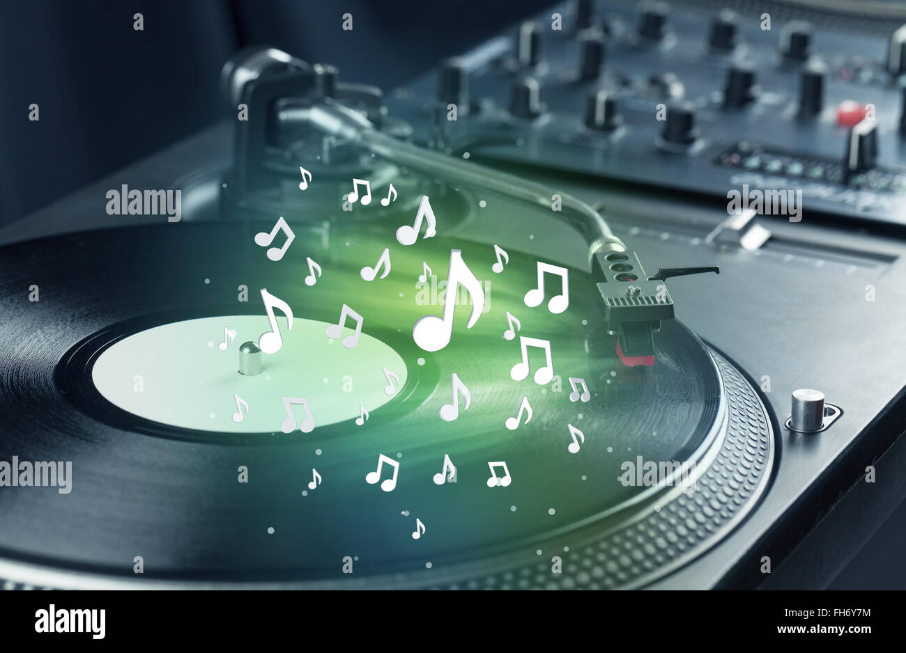 Turntable playing music with audio notes glowing Stock Photo - Alamy