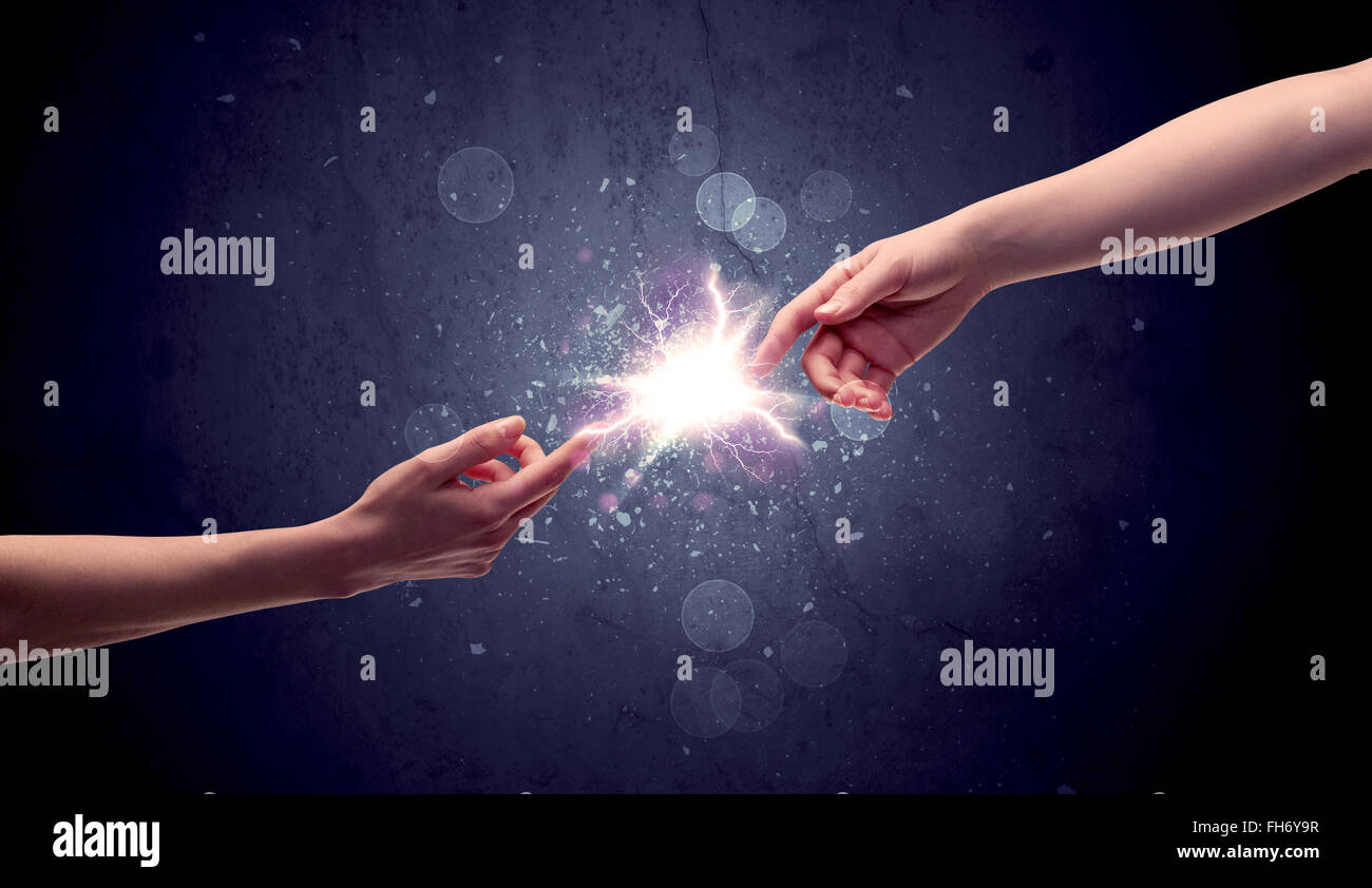 Hands reaching to light a spark Stock Photo - Alamy