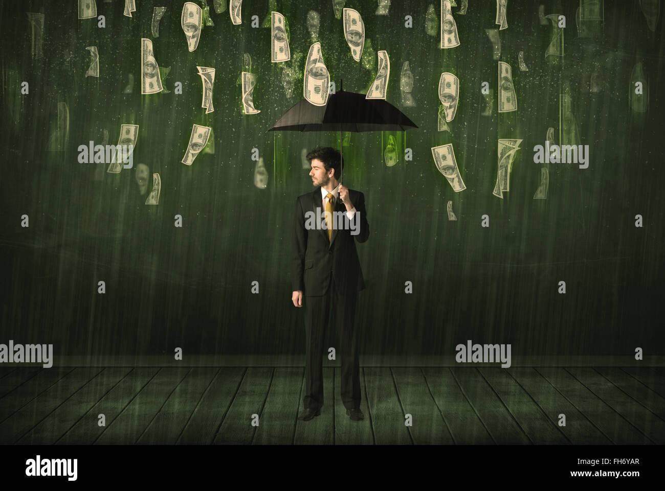 Businessman standing with umbrella in dollar bill rain concept Stock ...