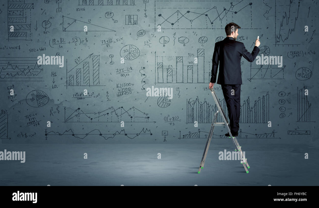 Man on ladder drawing charts Stock Photo - Alamy