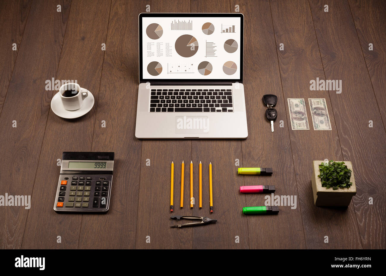 Pie chart graph icons on laptop screen with office accessories Stock ...