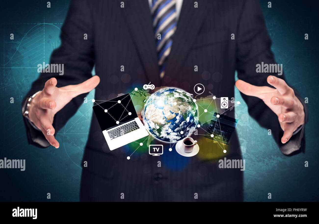 Business person holding laptop and globe Stock Photo - Alamy