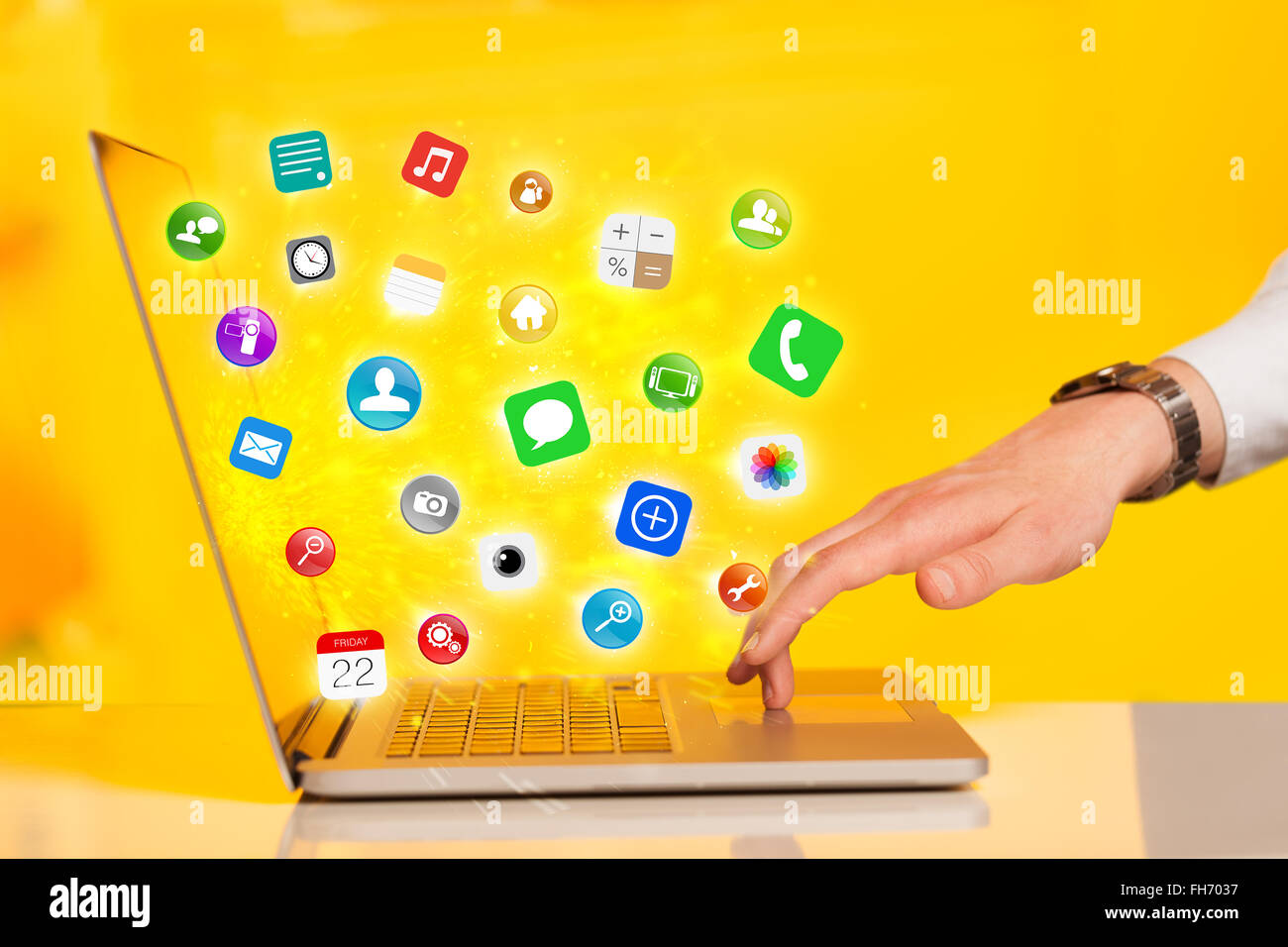 Hand pressing modern laptop with mobile app icons and symbols Stock ...
