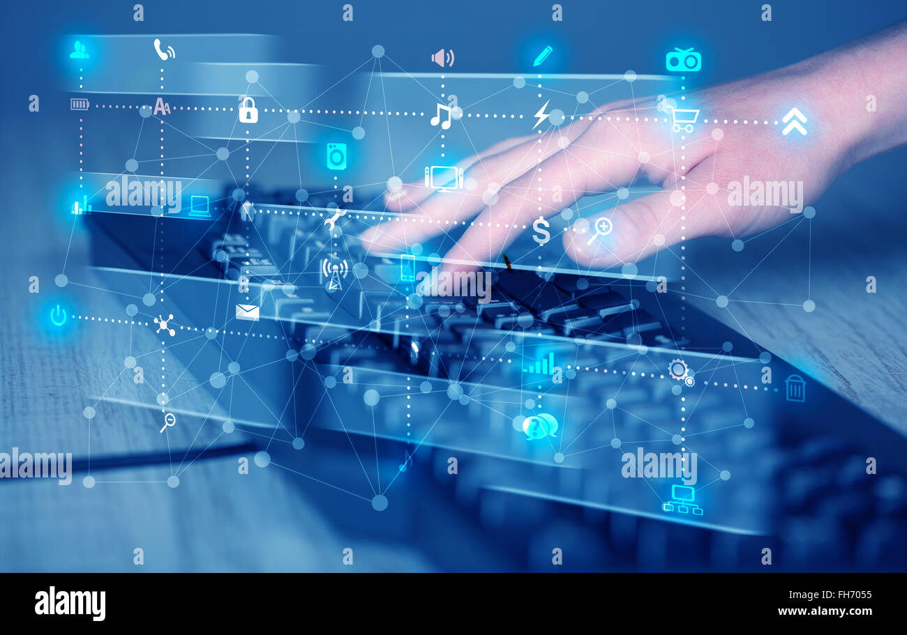 Hand pressing keyboard with high tech media icons Stock Photo - Alamy