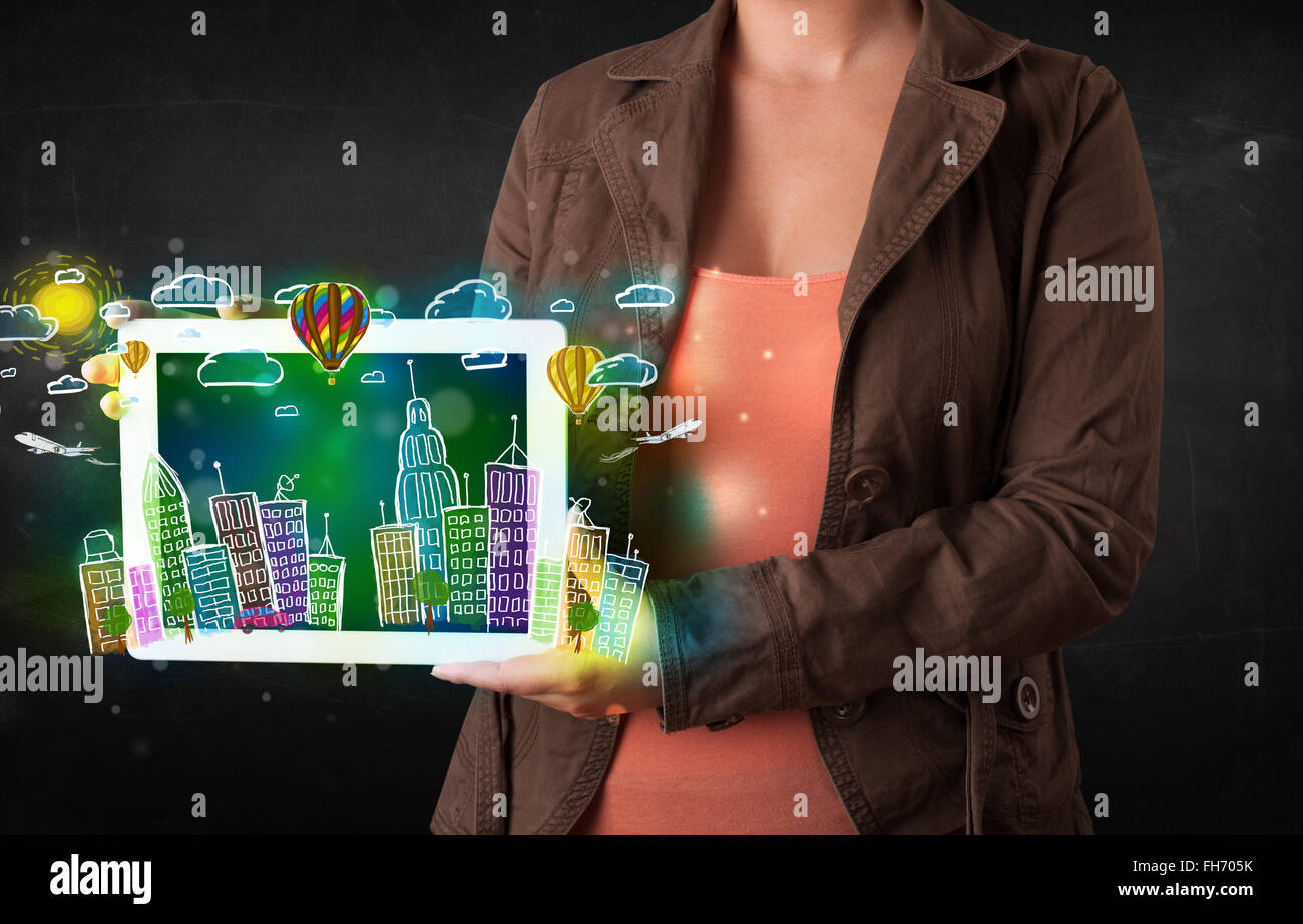Young person showing tablet with hand drawn cityscape Stock Photo - Alamy