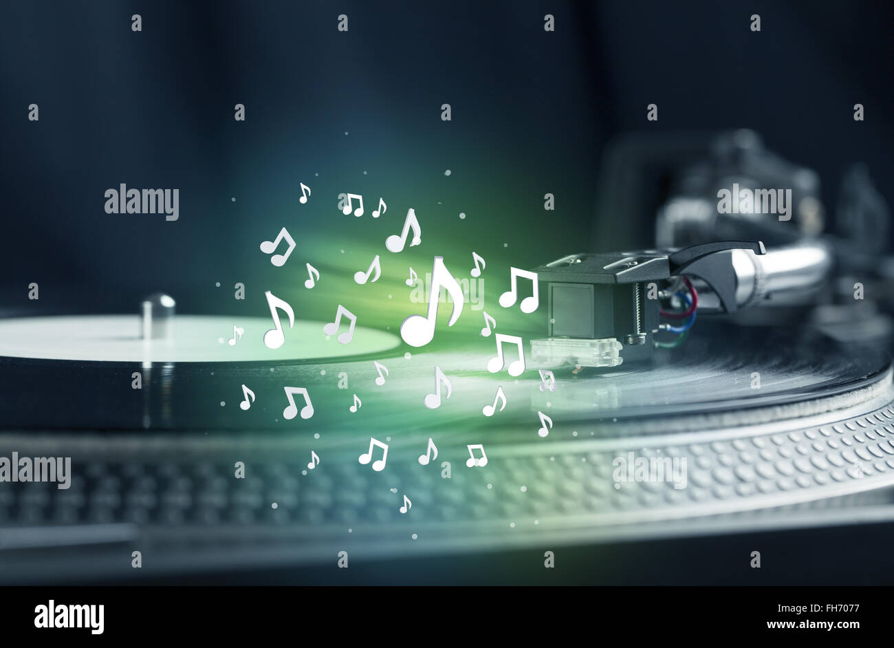 Turntable playing music with audio notes glowing Stock Photo - Alamy