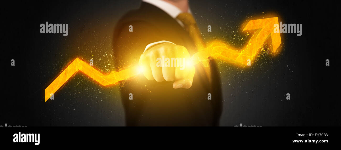 Business person holding a hot glowing upright arrow Stock Photo - Alamy