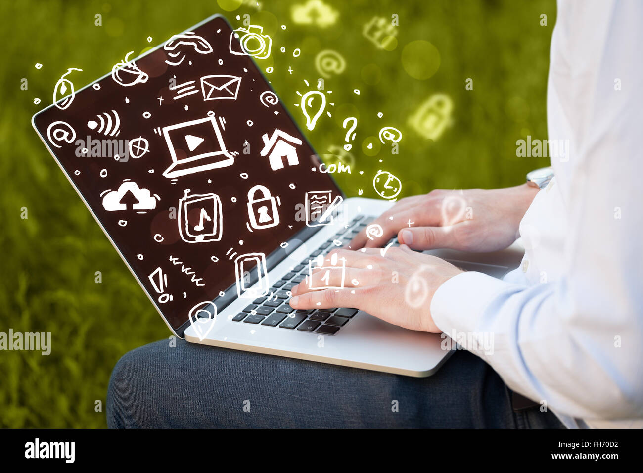 Hand writing on notebook computer with media icons and symbols Stock ...