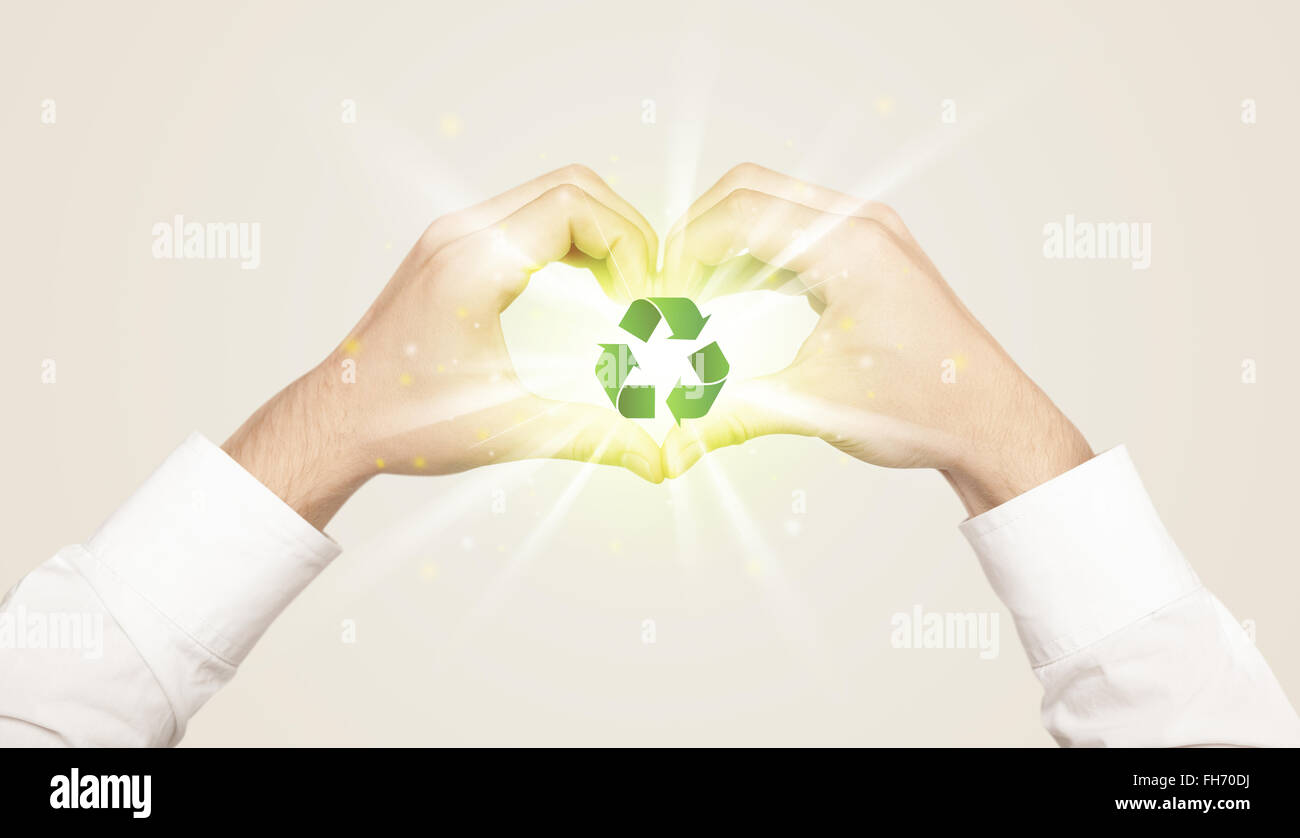 Hands creating a form with recycling sign Stock Photo - Alamy