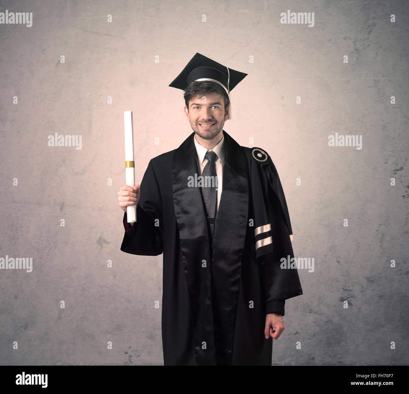 Portrait of a young graduate student on grungy background Stock Photo ...