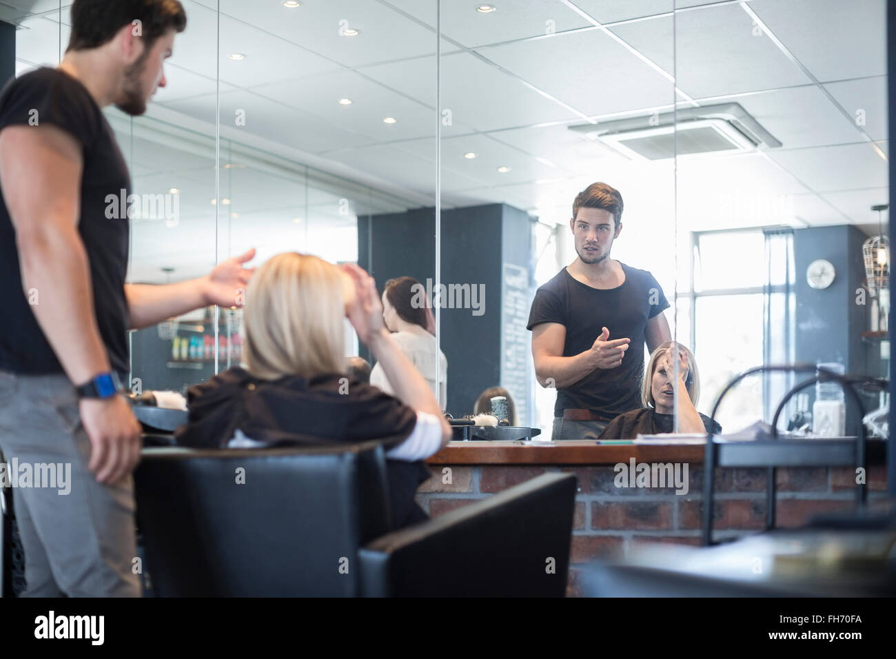 Woman in hair salon checking new hairstyle Stock Photo - Alamy