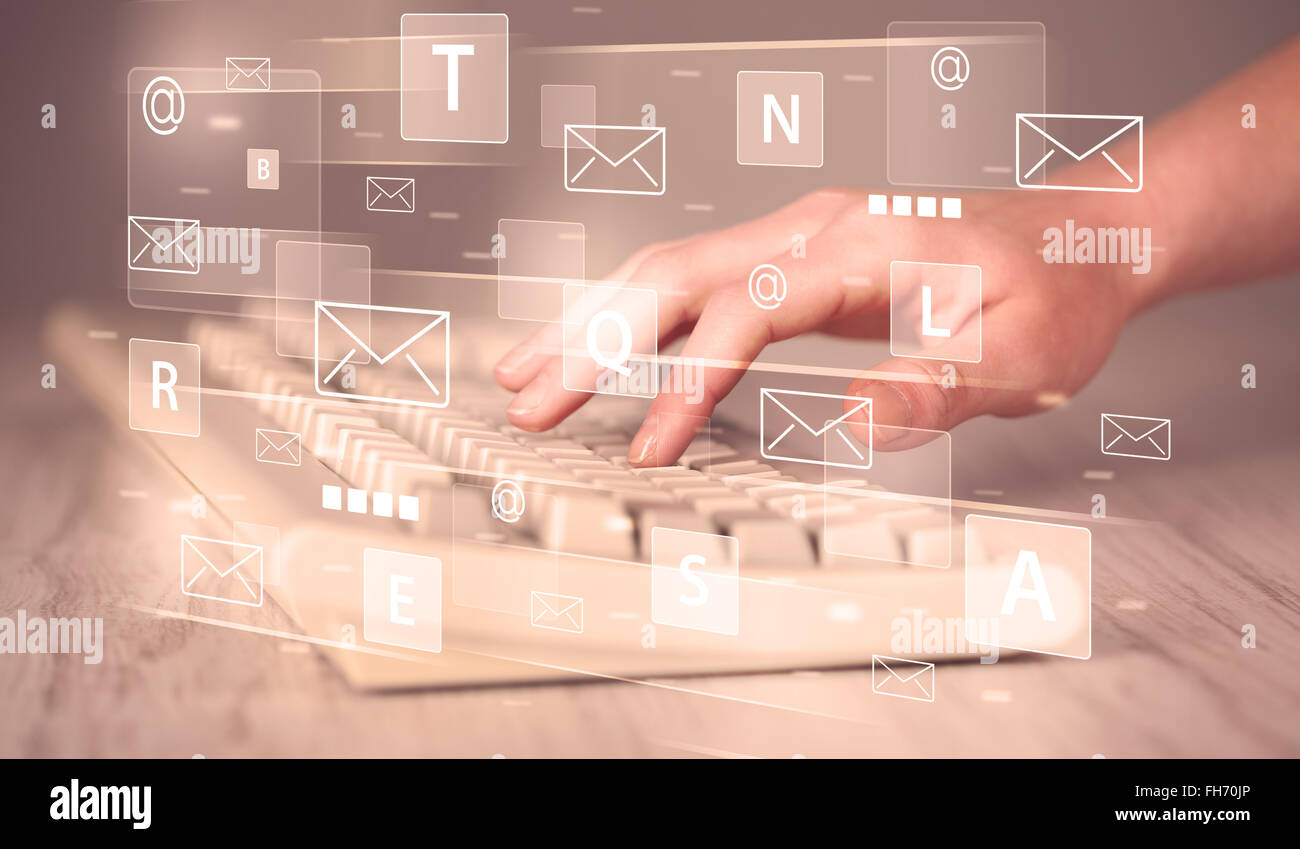 Hand typing on keyboard with digital tech icons Stock Photo - Alamy