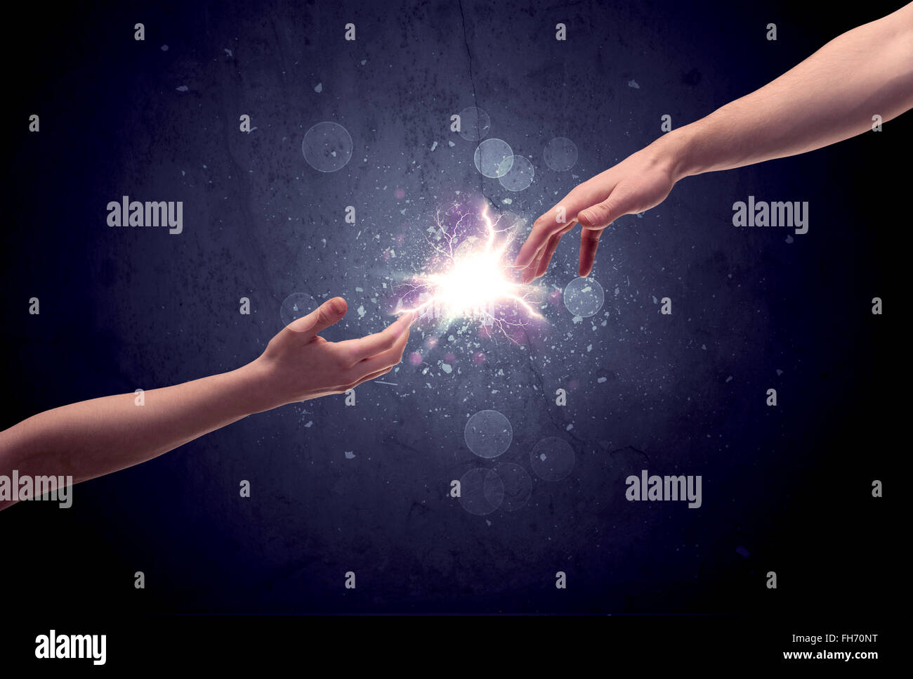 Hands reaching to light a spark Stock Photo - Alamy