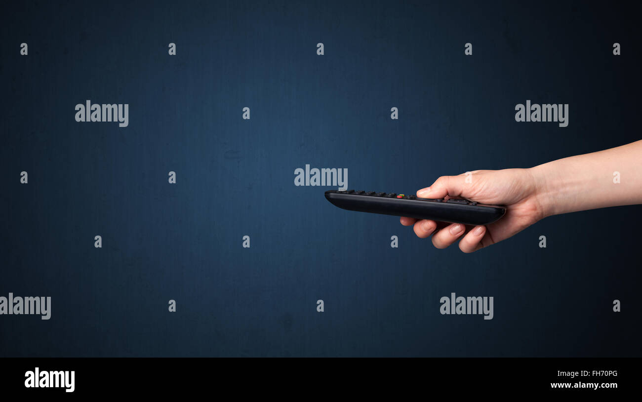 Hand with remote control Stock Photo - Alamy