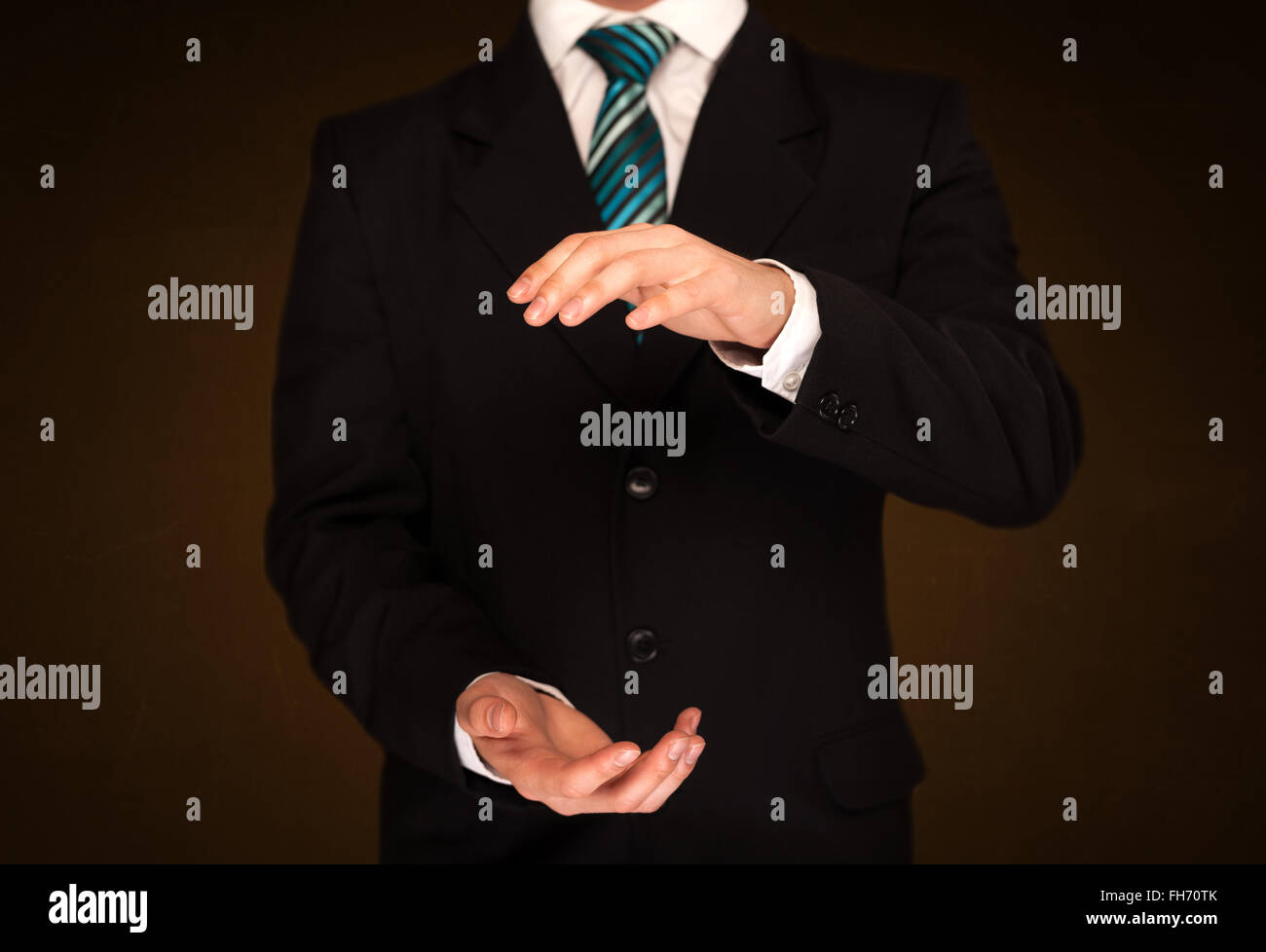 Businessman holding something Stock Photo - Alamy