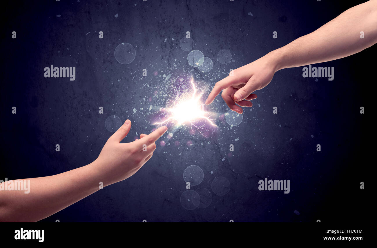 Hands reaching to light a spark Stock Photo - Alamy
