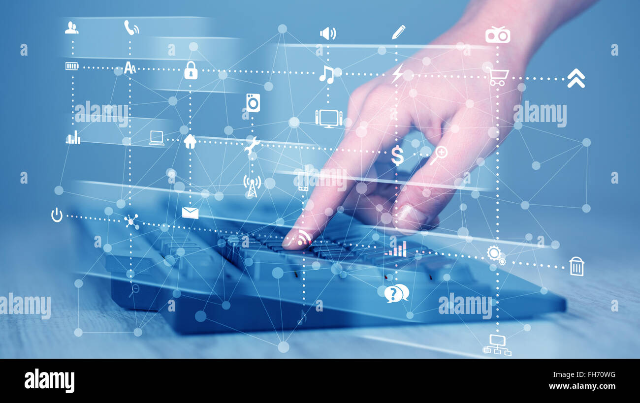 Hand pressing keyboard with high tech media icons Stock Photo - Alamy