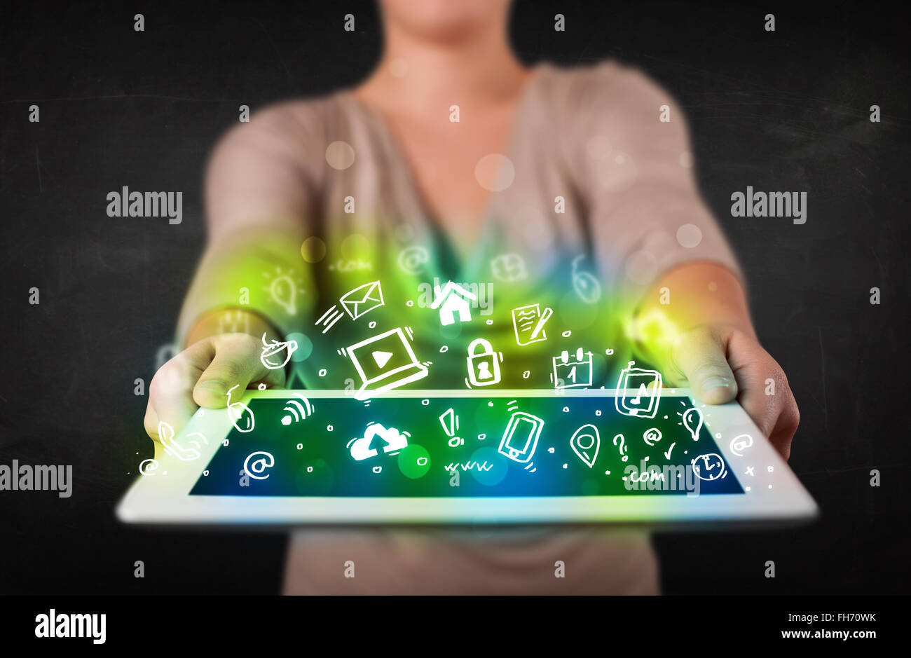 Person holding tablet with green media icons and symbols Stock Photo ...